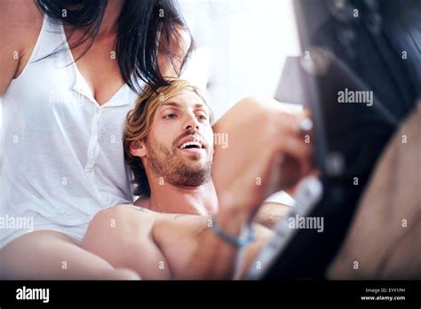 Casual Couple Using Laptop Stock Photo Alamy