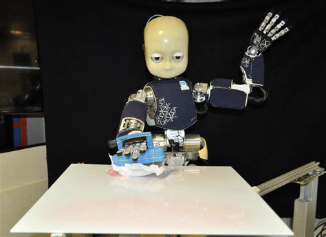 The Icub Humanoid Robot Using A Tool To Clean The Table In Front Of Him Download Scientific