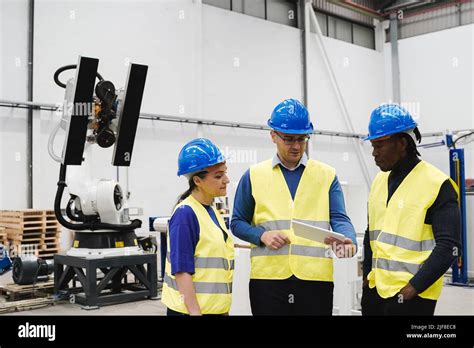 Industrial Engineers Working With Automated Arm Robot Inside Ai Robotic