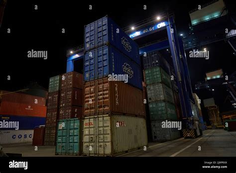 Operation Of Container Terminal At Night Unloading Container Ship At Night Stacks Of