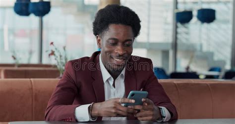A Man Dressed In A Suit Typing On His Phone Clicking His Fingers On A Smartphone Keyboard