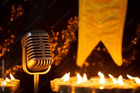 Retro Microphone With Row Many Tealight Candles Show With Yellow Sash