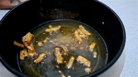 Tempeh Cooking Process Using Hot Cooking Oil Cooking Fried Tempeh With Electric Pan Stock