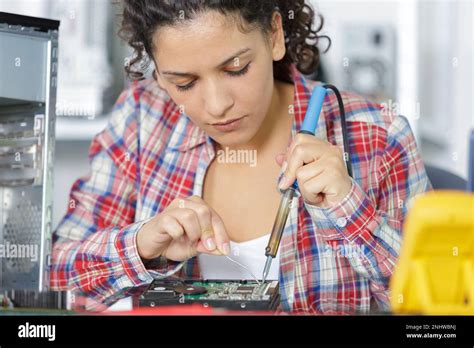 Woman Soldering Elements Of Circuit Board Stock Photo Alamy