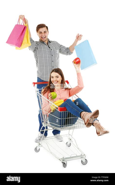 Man Carrying Woman In Metal Trolley With Products And Colorful Shopping Bags Isolated On White