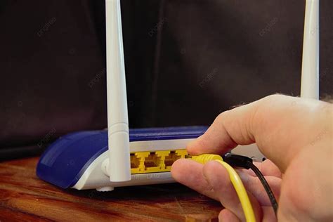 Inserting An Ethernet Cable Into A Wireless Router Photo Background And Picture For Free