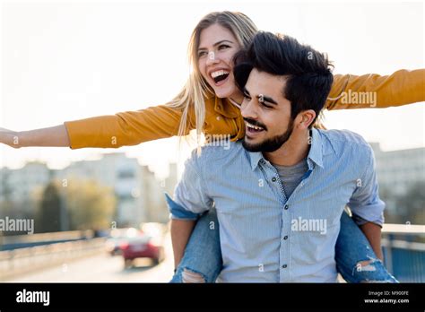 Couple In Love Cuddling While Enjoying Beautiful Urban Sunset Together