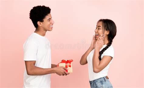 Young Guy Giving T To Young Girl Stock Image Image Of Celebration