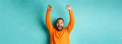 Free Photo Waistup Shot Of Happy Guy Celebrating Victory Rejoicing Of