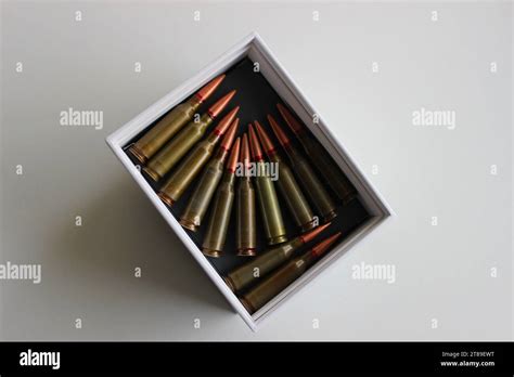 Top View Of White Box With Unitary Cartridges Lined Up Bullets To Bullets In A White Box Stock