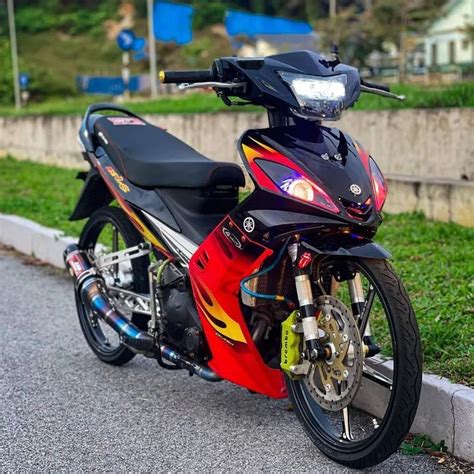 Red And Black Yamaha Motorcycle Parked On The Side Of The Road Red And Black Yamaha Motorcycle Parked On The Side Of The Road