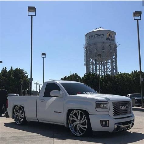 White Truck Parked In Front Of Water Tower