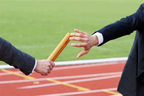 Premium Photo Close Up Of Businessmen Passing Equipment On Running Track