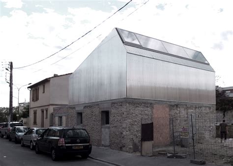 House Renovation By BAST Contrasts Old Brick Base With Metal Extension