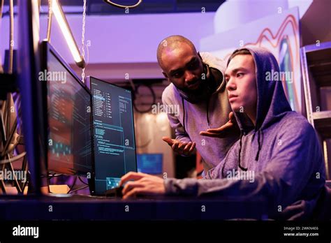 Hackers Discussing Cyberattack While Checking Spying Online And Using Malware On Computer Asian