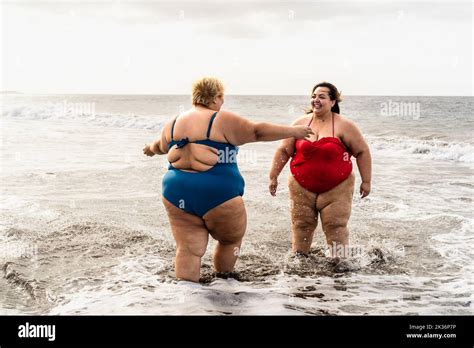 Happy Plus Size Women Having Fun On The Beach During Summer Vacation