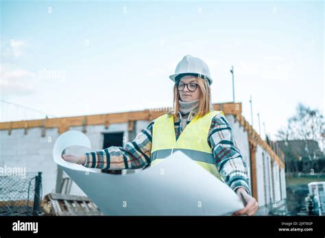 Portrait Of 30s Architect Engineer Womanin Clothes And Helmets With