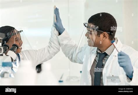 Case Solved Case Closed Two Scientists Giving Each Other A High Five While Working Together In