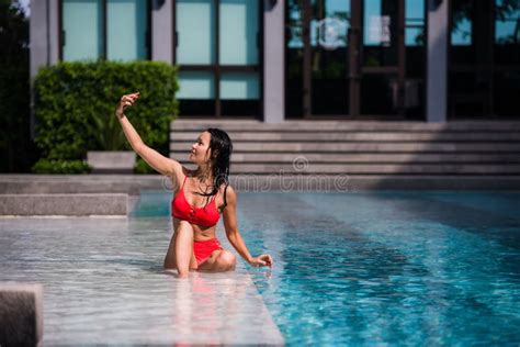 Beautiful Woman In Bikini Taking A Selfie By Pool Side On A Sunny Day