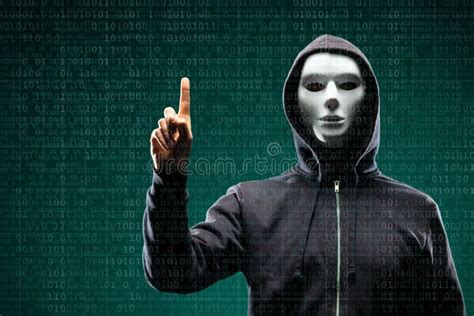 Computer Hacker In Mask And Hoodie Over Abstract Binary Background Obscured Dark Face Stock