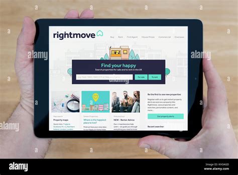 A Man Looks At The Rightmove Website On His Ipad Tablet Device Shot