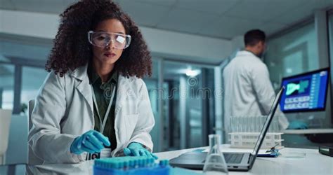 Scientist Woman And Typing On Laptop With Test Tube For Chemistry Research Or Experiment At