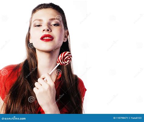 Young Pretty Brunette Girl With Red Candy Posing On White Backgr Stock