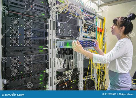 A Woman Installs A New Server In A Modern Data Center Girl System Administrator Works With