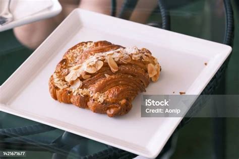 선택적 초점 호텔 아침 식사 베이커리와 패스트리 바의 흰색 접시 위에 아몬드 슬라이스가있는 신선한 크로와상 전통적인 프렌치 스위트 토스트 카페 배경의 제과점 아몬드 토스트