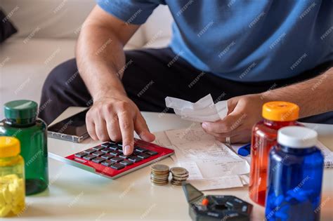 Premium Photo Male Calculating Costs Of Medicine While Holding Receipts