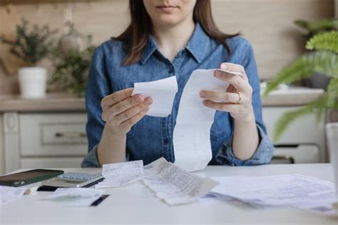 Premium Photo Woman Pays Bills And Utilities Counts The Amount Of Expenses And Income On A
