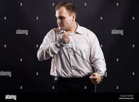 Man In White Shirt Pulling Chain Between Hands Stock Photo Alamy