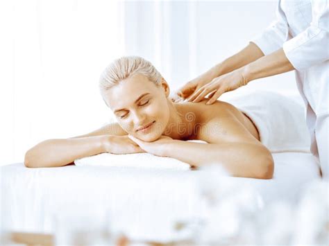 Beautiful Blonde Woman Enjoying Back Massage In Spa Center Beauty And