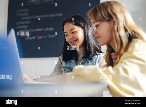 Female Students Working Collaboratively In A Coding Class To Learn