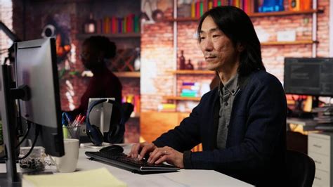 Portrait Of Smiling Senior Engineer Coding Advanced Ai Algorithm In Startup Office Refining