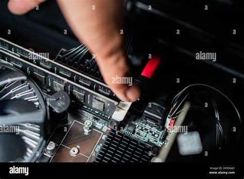 A Close Up Of A Persons Hand Installing Or Adjusting A Ram Module On A