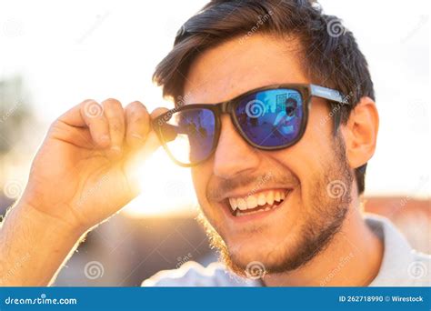 An Attractive Guy With Sunglass Posing For A Photo During The Sunset