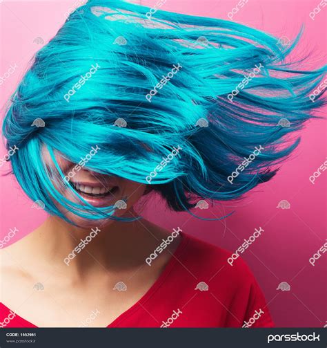 پرتره از یک مدل زن با موهای فیروزه ای در حرکت در زمینه صورتی 1552961