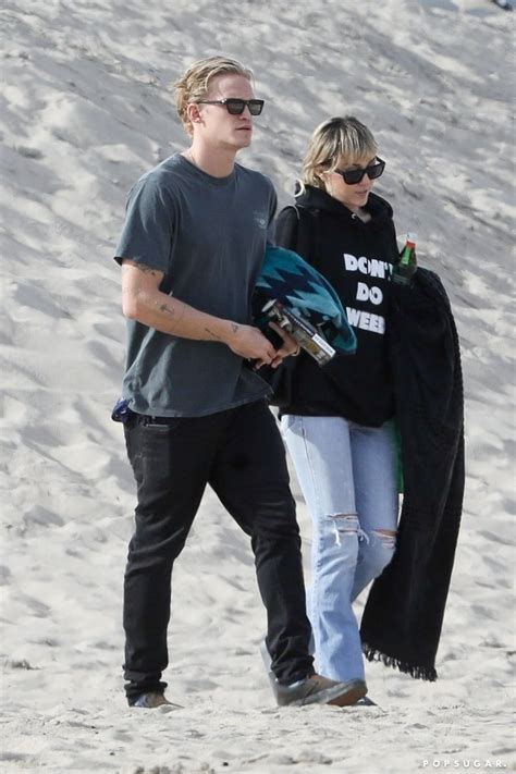 Miley Cyruss Black Swimsuit With Logo Straps At The Beach Ps Fashion