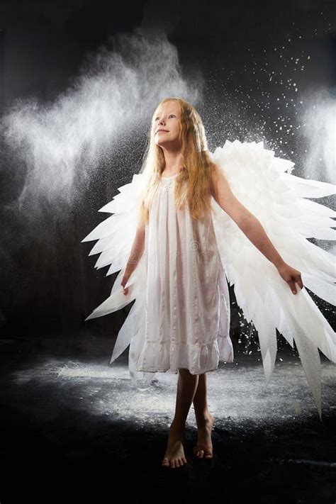 A Girl In A White Shirt Wings And With Long Hair Looking Like A Angel