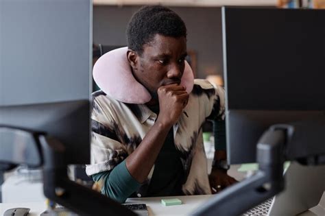 Premium Photo African American Developer Sitting At His Workplace With Computers In Office