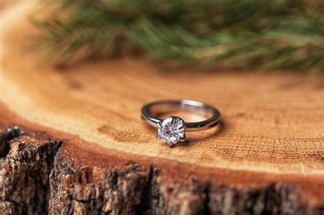 Premium Photo Engagement Ring On Tree Stump Closeup