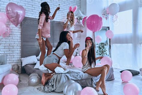 Quality Time With Friends Four Playful Young Smiling Women In Pajamas
