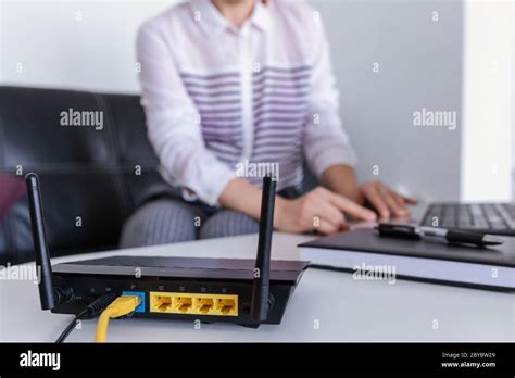 Wireless Router And Woman Using A Laptop In Office Router Wireless Broadband Home Laptop