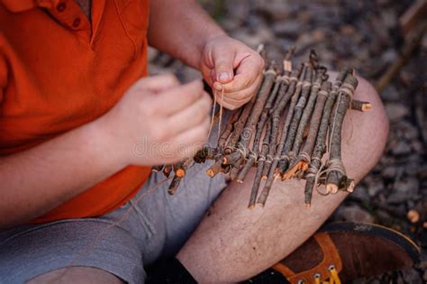 Man Crafting A Small Raft From Twigs And String Stock Image Image Of String Hands 371209403