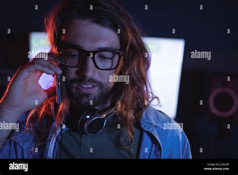Male Audio Engineer Talking On Mobile Phone In Recording Studio Stock Photo Alamy