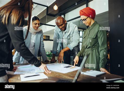 Innovative Interior Designers Discussing Colour Palettes During A