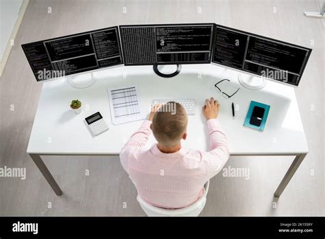 Computer Programmer Writing Program Code On Computer In Office Stock
