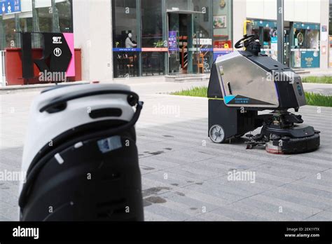 Two Cleaning Robots From Gaussian Robotics Work Under The Headquarter Of Gaussian Robotics In