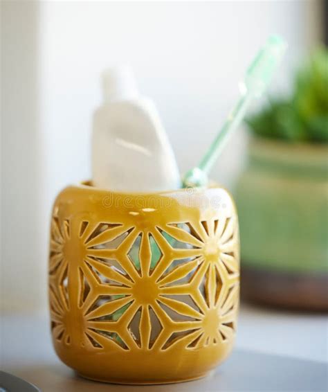 Container Toothbrush And Toothpaste In Bathroom Of Home And Closeup To Objects With Hygiene